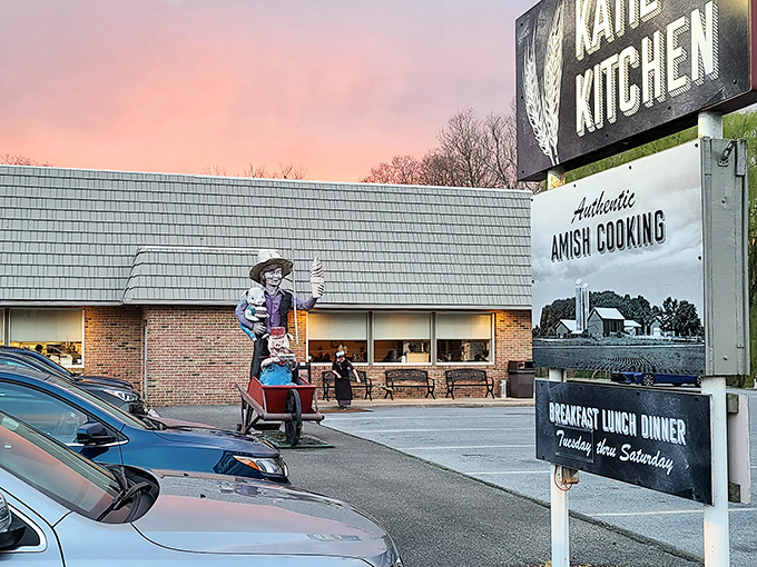 Katie's Kitchen glows at sunset, its "Authentic Amish Cooking" sign promising the kind of meal that makes you want to hug the chef afterward.