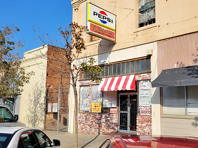 The unassuming exterior of Chef Paul's Cafe, with its vintage Pepsi sign and red-and-white awning, promises authentic flavors hiding in plain sight.