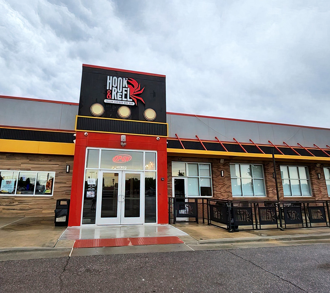 The bold red and black exterior of Hook & Reel stands out like a lighthouse for seafood lovers in Oklahoma City's dining landscape.