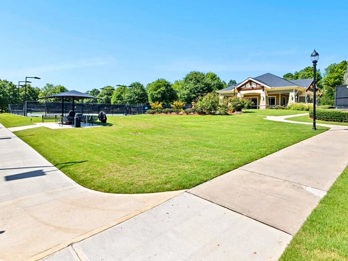 Tennis courts and clubhouse bathed in Georgia sunshine&mdash;where retirement means upgrading your backhand, not downgrading your lifestyle.