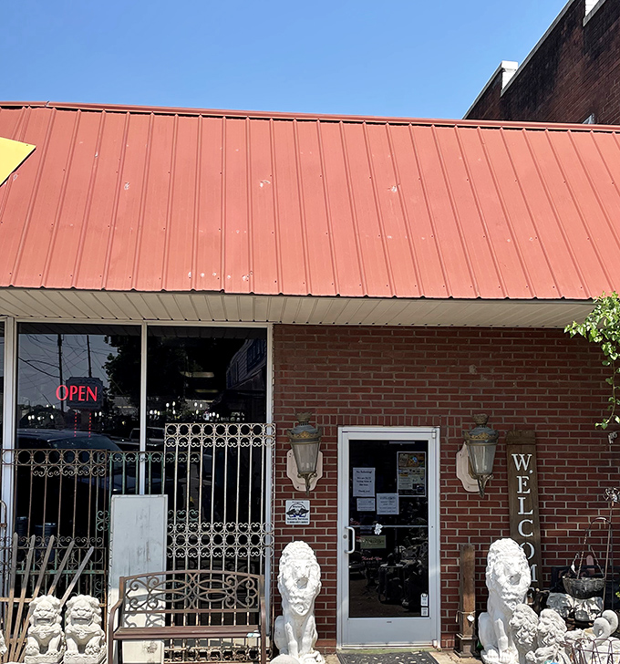 The brick facade and distinctive red roof of Goodlettsville Antique Mall promise treasures within. Like a time machine disguised as a storefront.