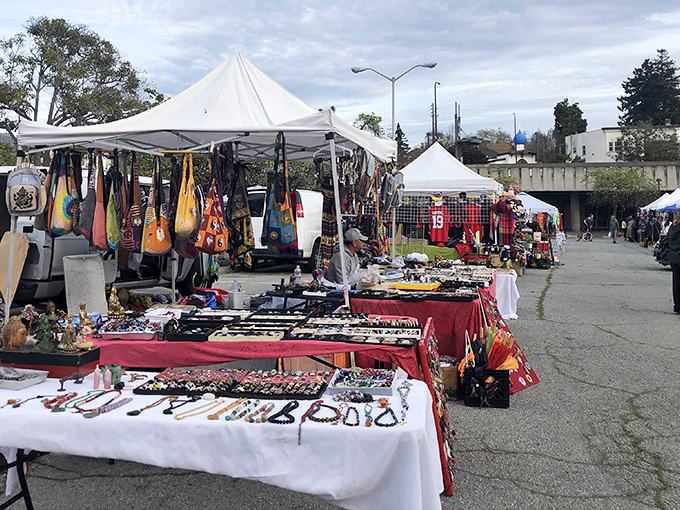 The weekend transformation begins: rows of white tents line the Ashby BART parking lot, turning ordinary asphalt into a treasure hunter's paradise.