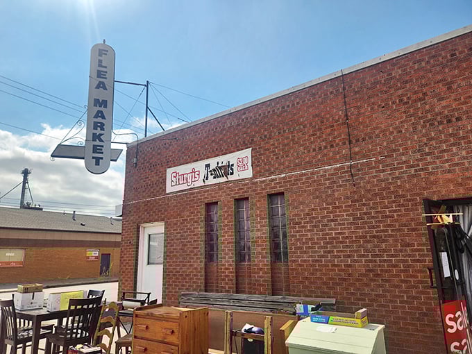 The iconic brick facade of Junktion Flea Market stands proudly under Nebraska skies, its vintage sign promising treasures within like a beacon to bargain hunters.