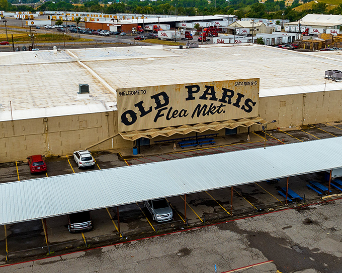 The iconic Old Paris Flea Market sign stands proudly against the Oklahoma sky, a beacon for treasure hunters and nostalgia seekers alike.