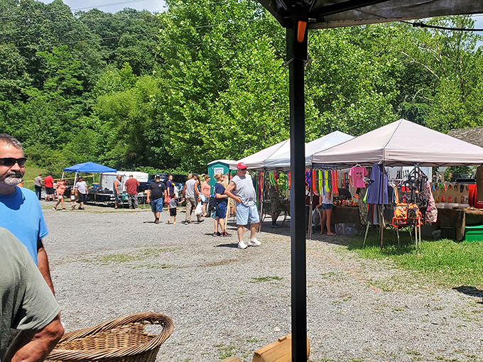 Treasure hunters navigate the gravel paths between colorful tents, where one person's castoffs become another's prized finds.