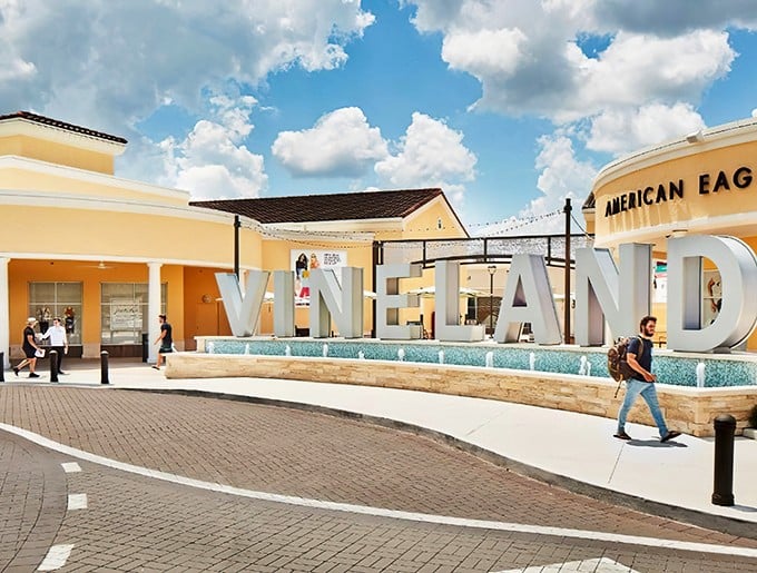 The iconic VINELAND sign welcomes shoppers to retail paradise under Florida's perfect blue skies—a siren call to bargain hunters everywhere.