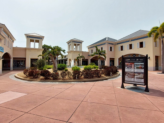 Mediterranean-inspired architecture welcomes shoppers to Ellenton Premium Outlets, where palm trees and beige facades create a shopping oasis rather than just another mall.