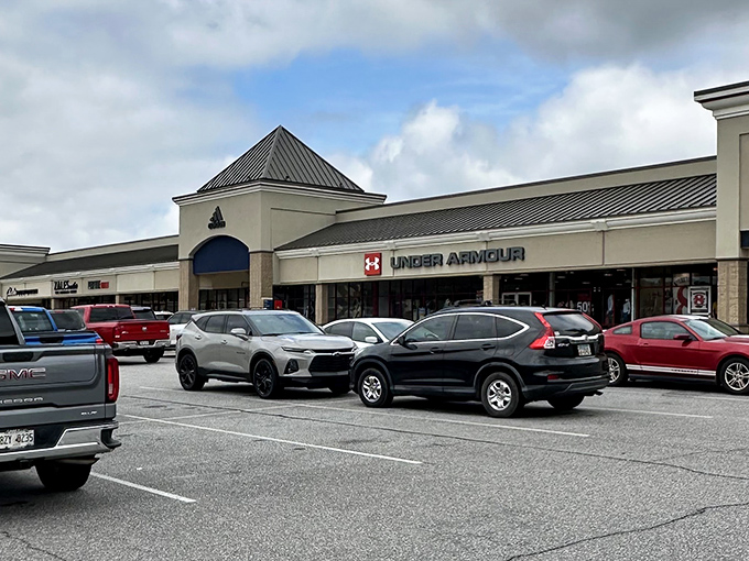 The retail promised land awaits! Under Armour's prominent signage beckons shoppers to the athletic wear paradise at Tanger Outlets Commerce.