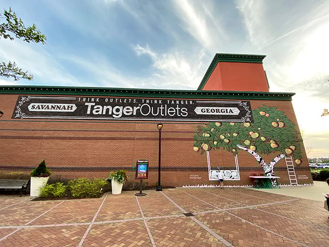 The iconic brick facade of Tanger Outlets stands tall like a retail promised land, with its peach tree mural a proud nod to Georgia charm.