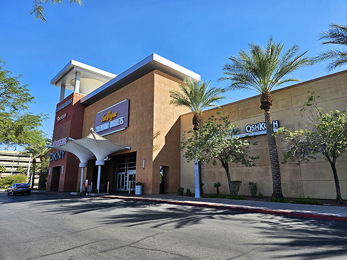 The desert sun gleams off Las Vegas South Premium Outlets' tan stucco facade, where palm trees stand guard over fashion treasures waiting to be discovered.