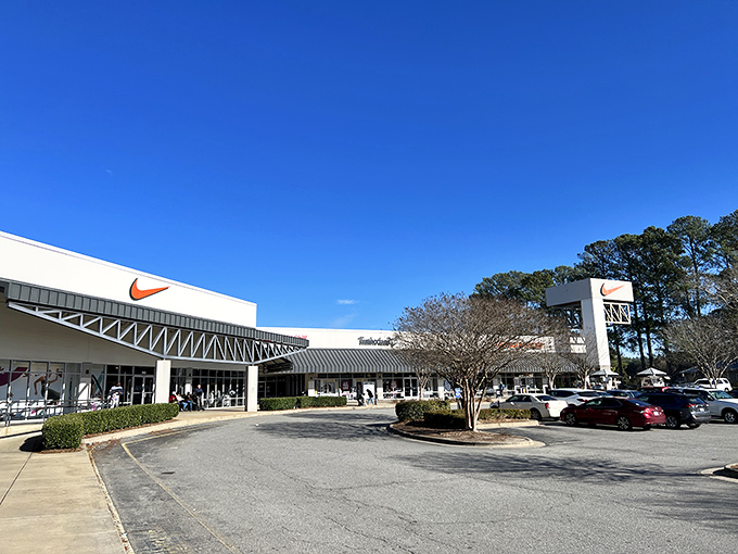 Nike's iconic swoosh stands sentinel at the entrance, a beacon for athletic wear enthusiasts and bargain hunters alike.