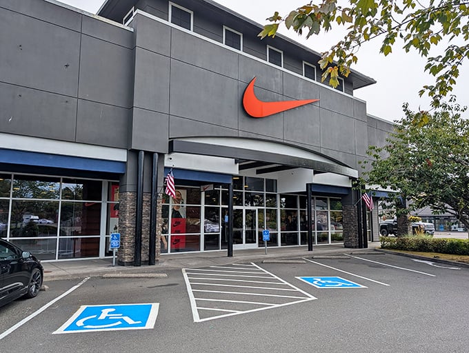 The modern exterior of the Seaside Outlet Mall beckons bargain hunters with that iconic swoosh overhead.