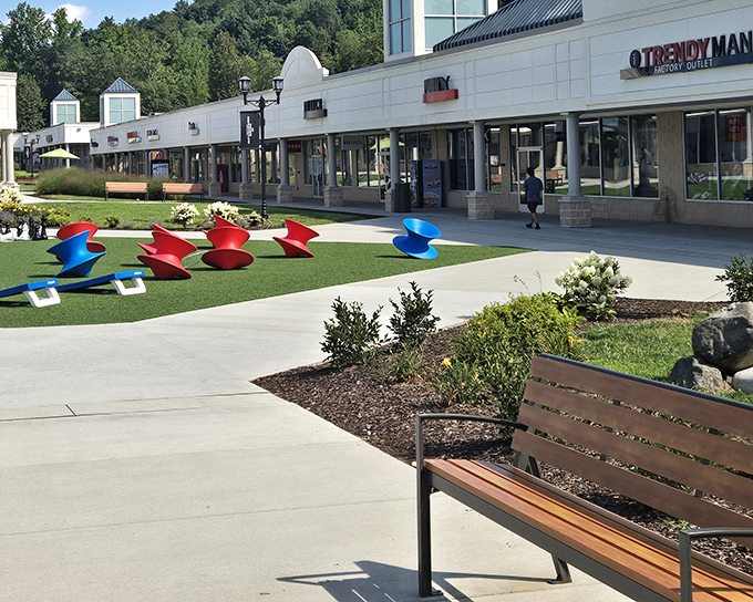 The pristine walkways of Pocono Premium Outlets invite shoppers with colorful sculptures and comfortable benches&mdash;retail therapy with mountain air included.