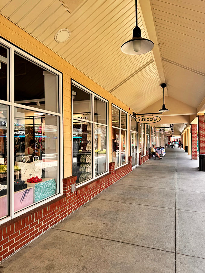 The grand entrance to Tanger Outlets stands like a retail Colosseum, beckoning shoppers with promises of discounted treasures within.