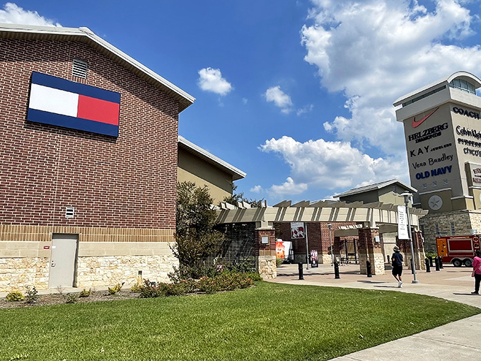 The iconic Tommy Hilfiger storefront welcomes shoppers to Houston Premium Outlets, where Texas-sized deals await behind that familiar red, white, and blue logo.