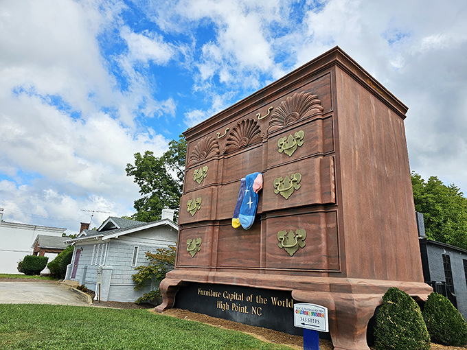 Standing tall against Carolina blue skies, this 38-foot dresser proves that sometimes, the most memorable landmarks come with drawers and giant socks.