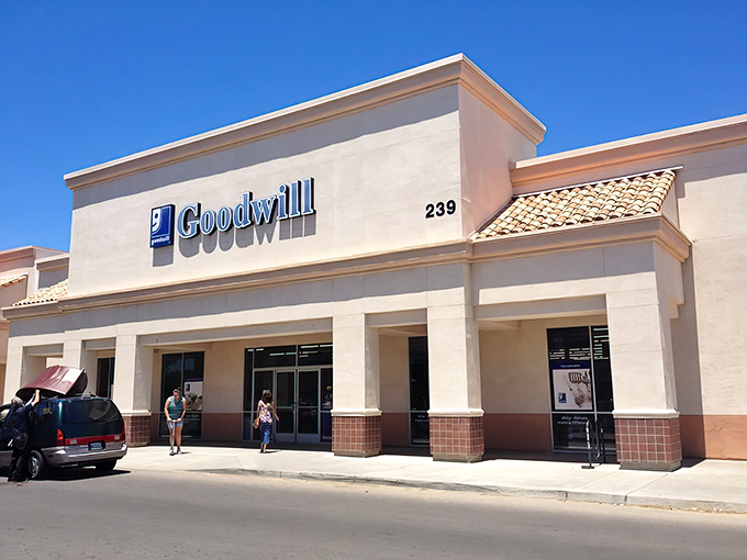 The desert-toned exterior of Goodwill Clovis stands like a mirage of bargains under that brilliant California blue sky.