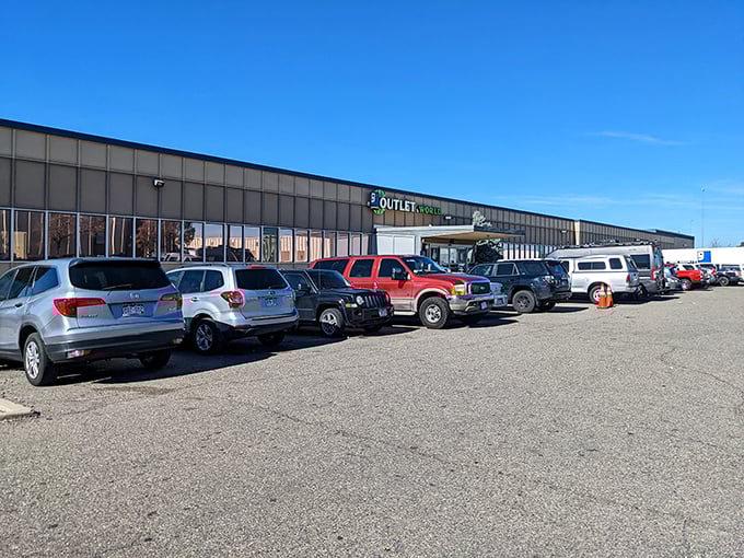 The unassuming exterior of Denver's Goodwill Outlet World, where treasure hunters' vehicles fill the lot like prospectors at a modern-day gold rush.