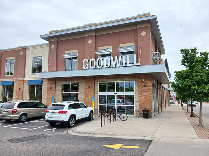 The modern brick facade of Goodwill on University Avenue stands like a beacon for treasure hunters, promising adventures in pre-loved merchandise behind those welcoming glass doors.
