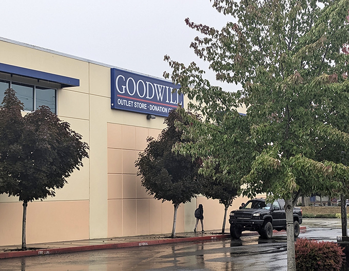The unassuming exterior of bargain paradise. Behind this beige facade lies a treasure trove where savvy Oregonians fill carts for pocket change.