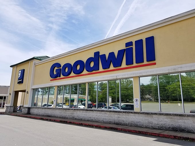 The blue Goodwill sign glows like a beacon of bargain-hunting hope against the Arkansas sky. Treasure awaits inside!