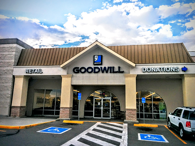 The Arvada Goodwill welcomes treasure hunters with its distinctive blue logo and promise of retail adventures waiting just beyond those sliding doors.