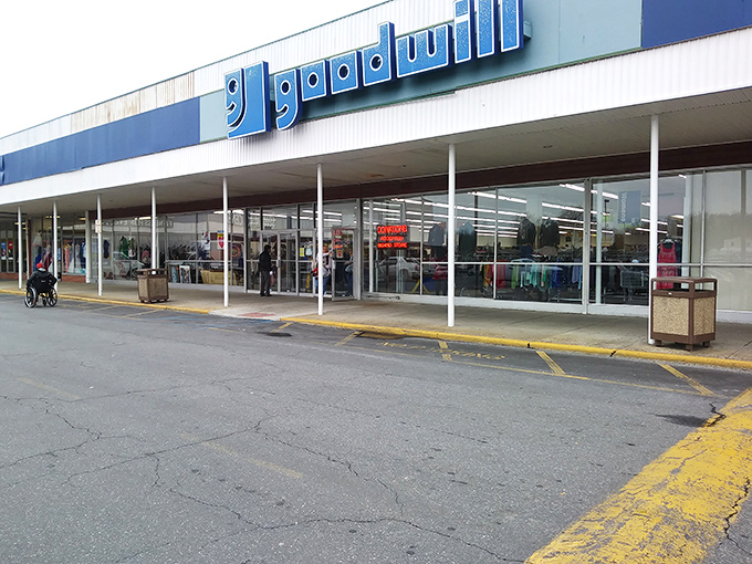 The iconic blue and white Goodwill storefront beckons treasure hunters with promises of undiscovered gems and budget-friendly adventures waiting just beyond those sliding doors.
