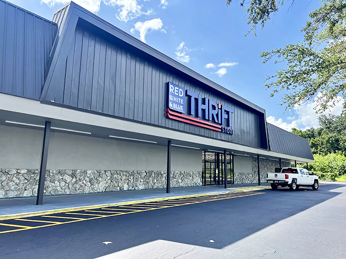 The blue facade of Red White and Blue Thrift Store stands proudly against the Florida sky, like a patriotic beacon calling bargain hunters home.
