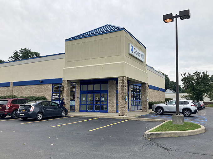 A beige building with blue trim might not scream "shopping paradise," but savvy bargain hunters know this Goodwill location delivers the goods.