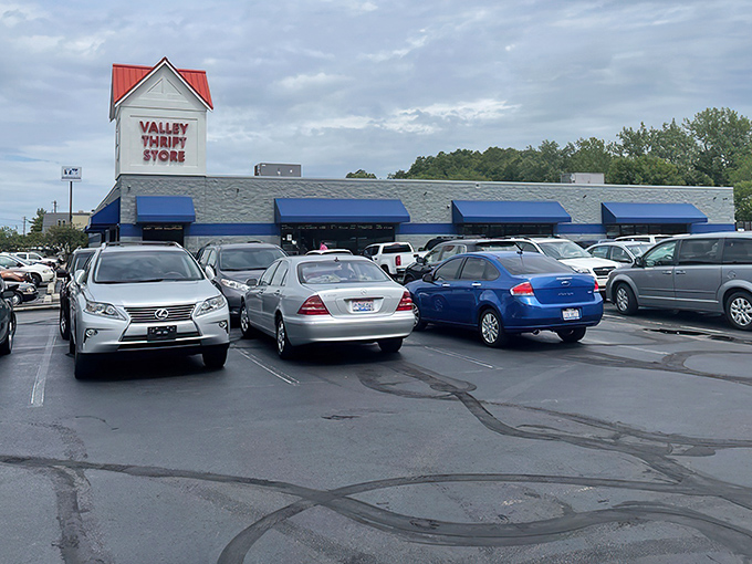The blue signage of Valley Thrift Store stands out against the white building like a beacon for bargain hunters across Cincinnati.
