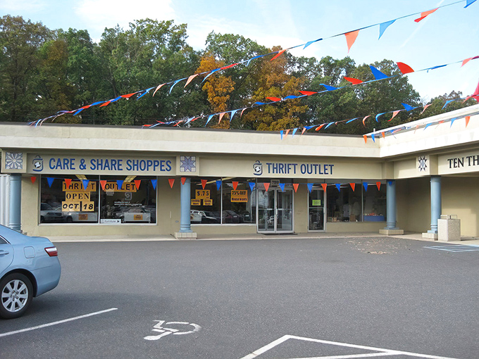 Colorful pennants dance above the entrance like a carnival of bargains, inviting shoppers to this thrifting wonderland.