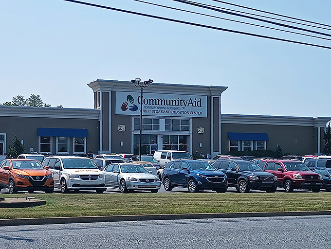 The welcoming facade of CommunityAid beckons with its colorful handprint logo&mdash;like a high-five promising bargains inside.