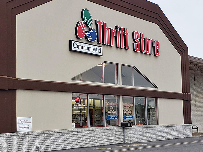 The CommunityAid storefront stands like a beacon of bargain hope, promising treasures within its unassuming exterior. Thrift nirvana awaits!