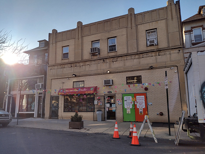 That burgundy awning welcomes bargain hunters like a lighthouse beacon guiding treasure seekers to thrift store paradise.