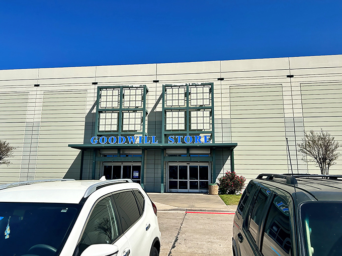 The Goodwill Store on Westmoreland stands like a beacon of bargain possibilities under the bright Texas sky, promising treasures within its unassuming exterior.