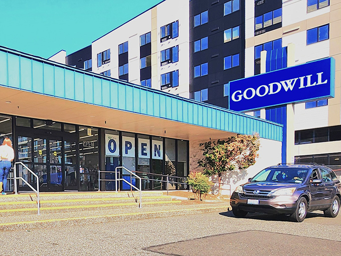 The bright blue Goodwill sign beckons like a thrifty lighthouse, guiding bargain hunters safely to shore in Lynnwood's sea of retail options.