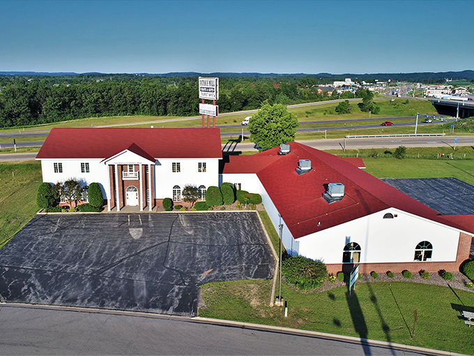 The stately white building with its distinctive red roof stands like a temple to nostalgia, beckoning treasure hunters from Interstate 90/94 with promises of discoveries within.