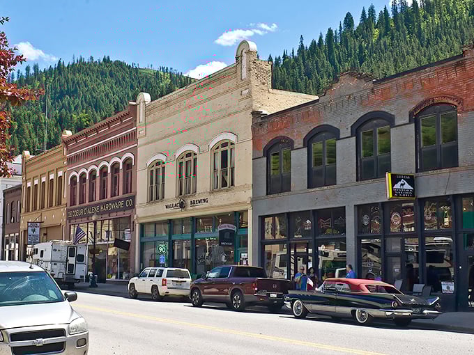 Historic storefronts stand shoulder-to-shoulder like old friends, their Victorian charm perfectly framed by the emerald mountains that cradle this Silver Valley gem.