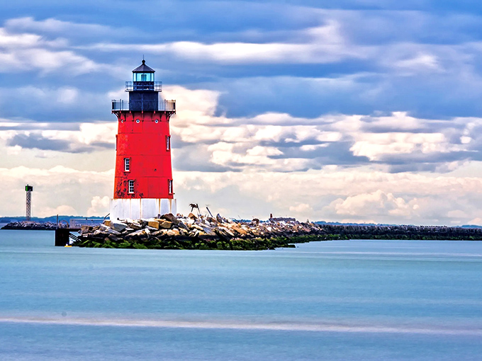 Standing tall against a dramatic sky, this crimson sentinel has guided mariners safely through Delaware Bay for generations.
