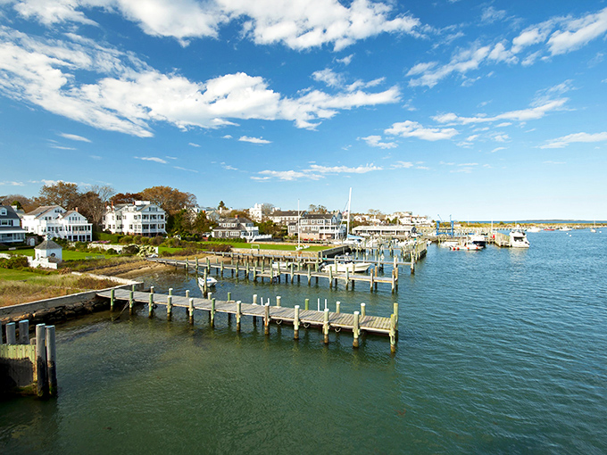 Edgartown Harbor sparkles like nature's own diamond necklace, with white clapboard homes standing sentinel over wooden docks that stretch into the blue beyond.