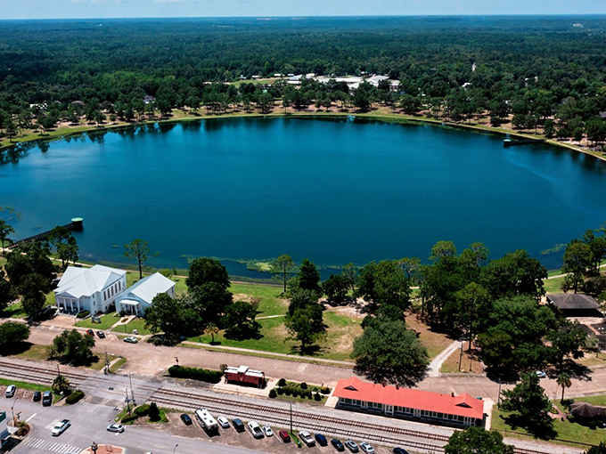 Lake DeFuniak shimmers like a perfect sapphire, surrounded by historic buildings and lush greenery &ndash; Mother Nature's own retirement community centerpiece.