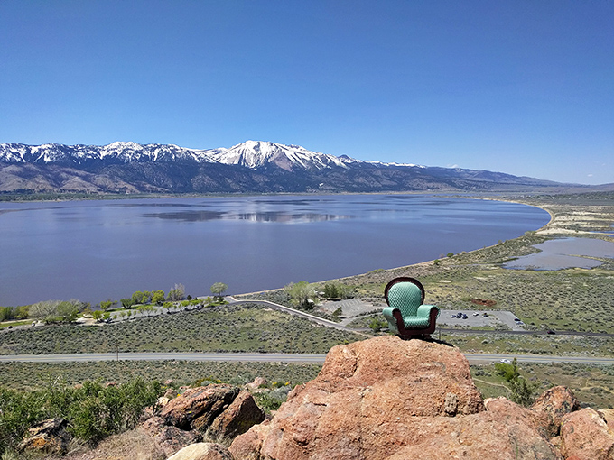 Talk about a room with a view! From this rocky perch, Washoe Lake spreads out like nature's infinity pool, with snow-capped mountains standing guard in the distance.