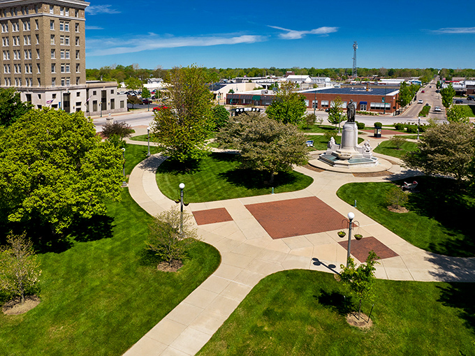 The town square serves as Jacksonville's living room, where community events unfold beneath blue Midwestern skies and century-old shade trees.