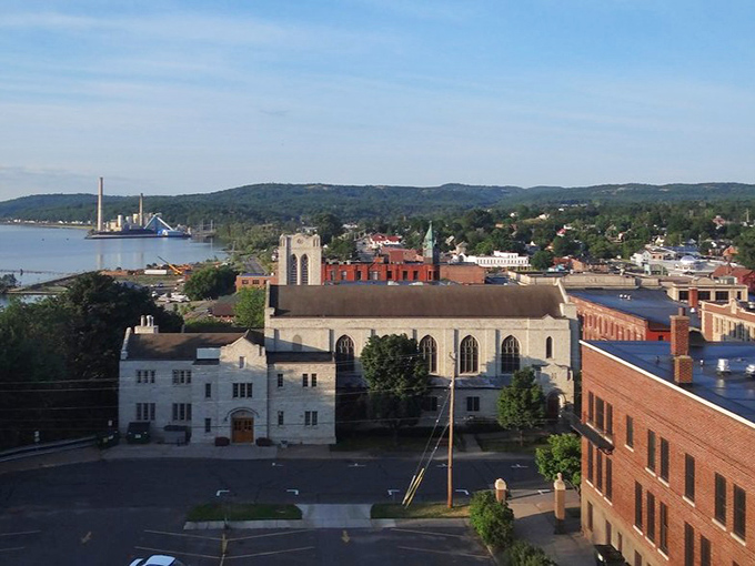 Historic sandstone buildings line Marquette's downtown streets, where 19th-century architecture meets small-town charm under perfect Michigan skies.