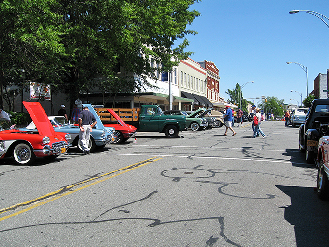 Classic cars line downtown Burlington during a car show, where chrome gleams under Carolina blue skies and stories flow as freely as sweet tea.