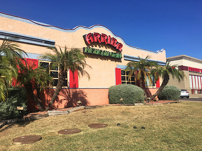 Like a mirage in the Phoenix heat, Arriba's welcoming exterior promises culinary salvation with its distinctive wavy roofline and palm trees standing sentinel.