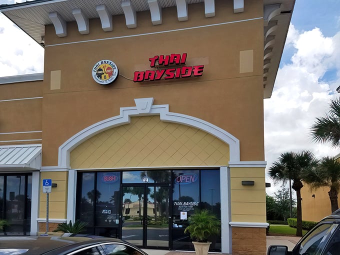 Thai Bayside's bright red signage stands out against the Florida sky, a beacon for hungry travelers seeking authentic flavors.