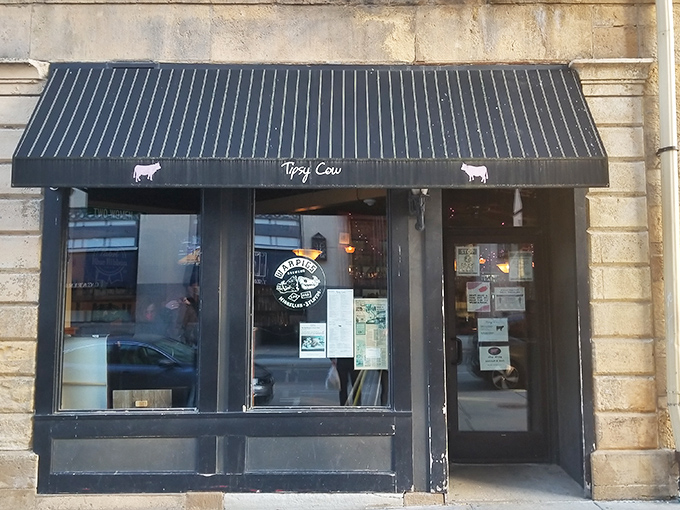 The unassuming storefront of Tipsy Cow beckons with its simple black awning and cow silhouettes—like that friend who doesn't brag but always delivers the goods.