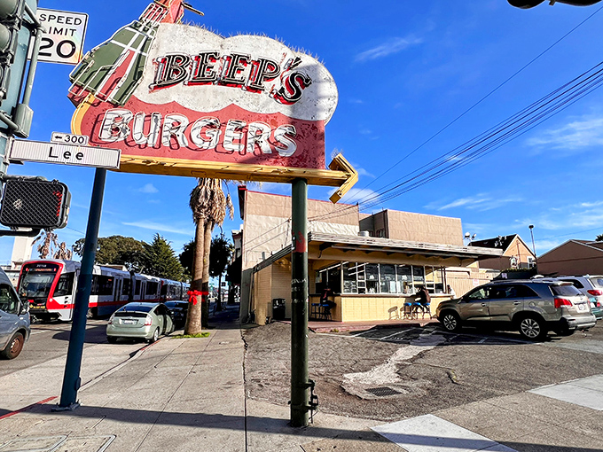 The iconic Beep's Burgers sign stands sentinel on Ocean Avenue, a neon-lit promise of culinary nostalgia that's been keeping its word for decades.