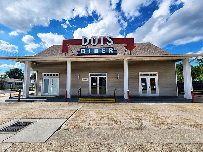 The iconic red sign beckons like a lighthouse for hungry souls. Dots Diner's unassuming exterior houses breakfast treasures that locals have cherished for generations.